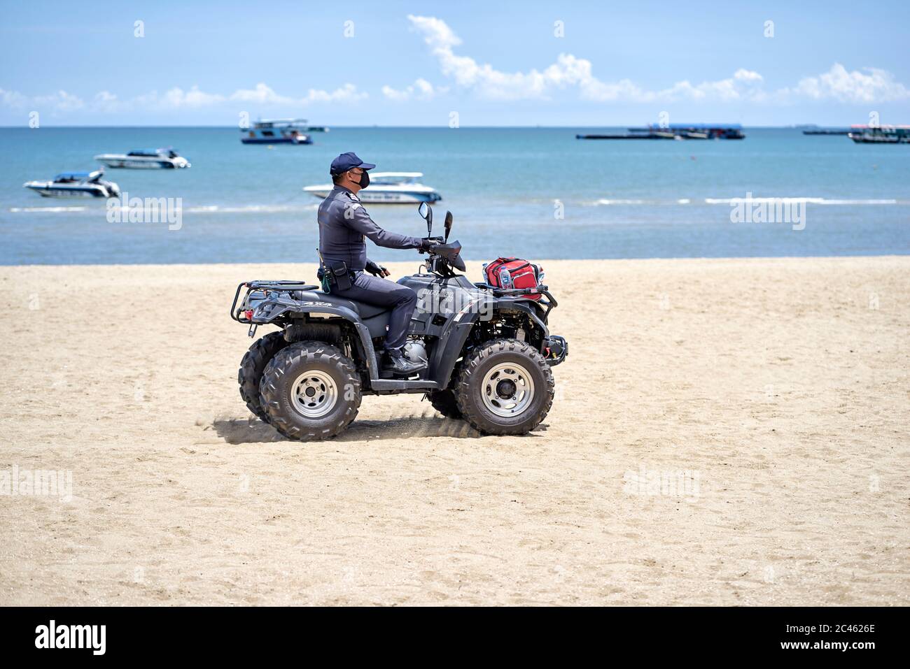 Beach patrol officer and ATV sand buggy quad bike vehicle. Pattaya ...