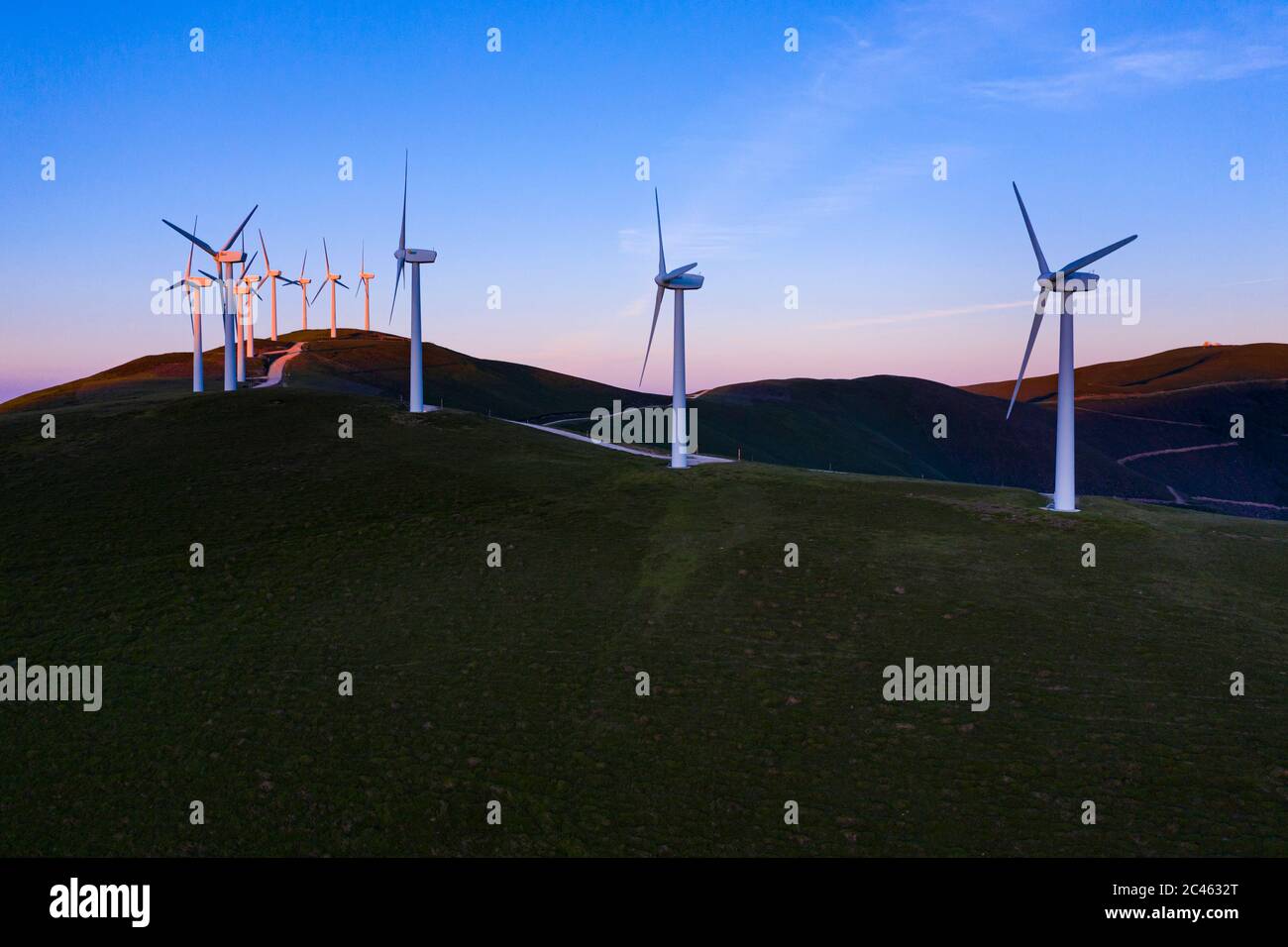 Wind farm at sunset with a drone in Portillo de la Sia between the ...