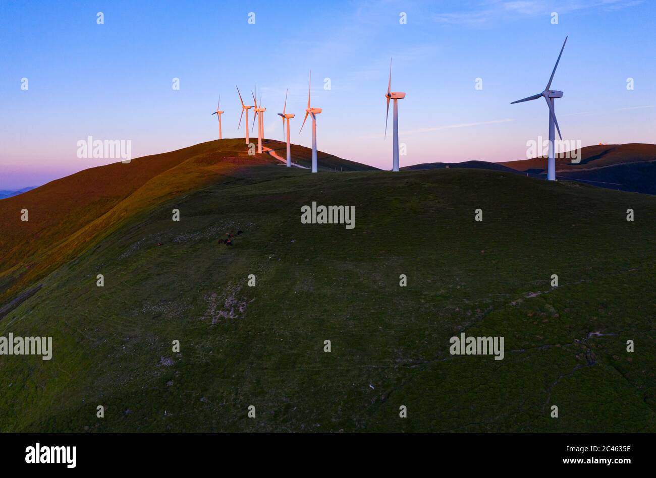 Wind farm at sunset with a drone in Portillo de la Sia between the ...