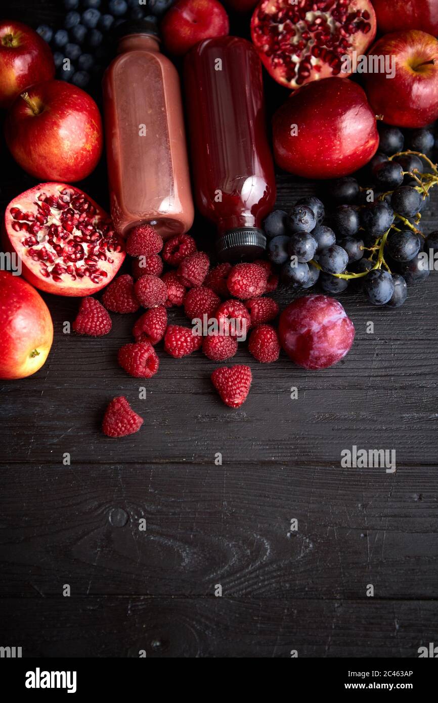 Various fresh red, purple black fruits. Mix of fruits and bottled ...