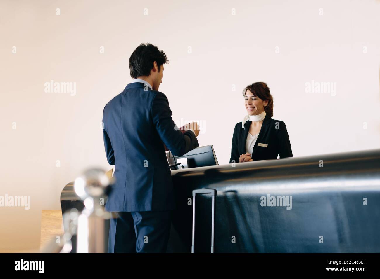 Businessman making contactless payment at hotel reception Stock Photo ...