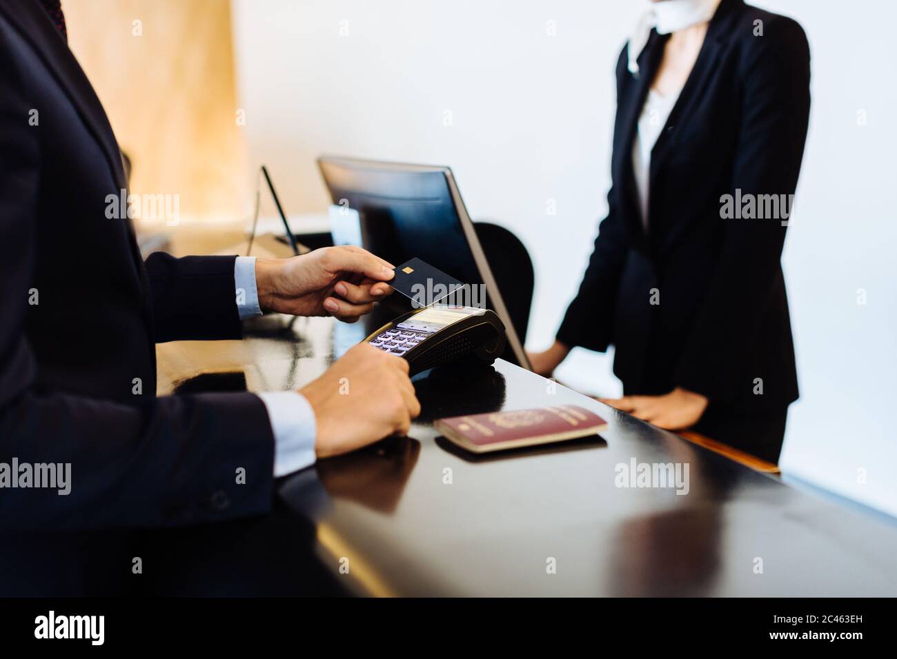Businessman making contactless payment at hotel reception Stock Photo ...