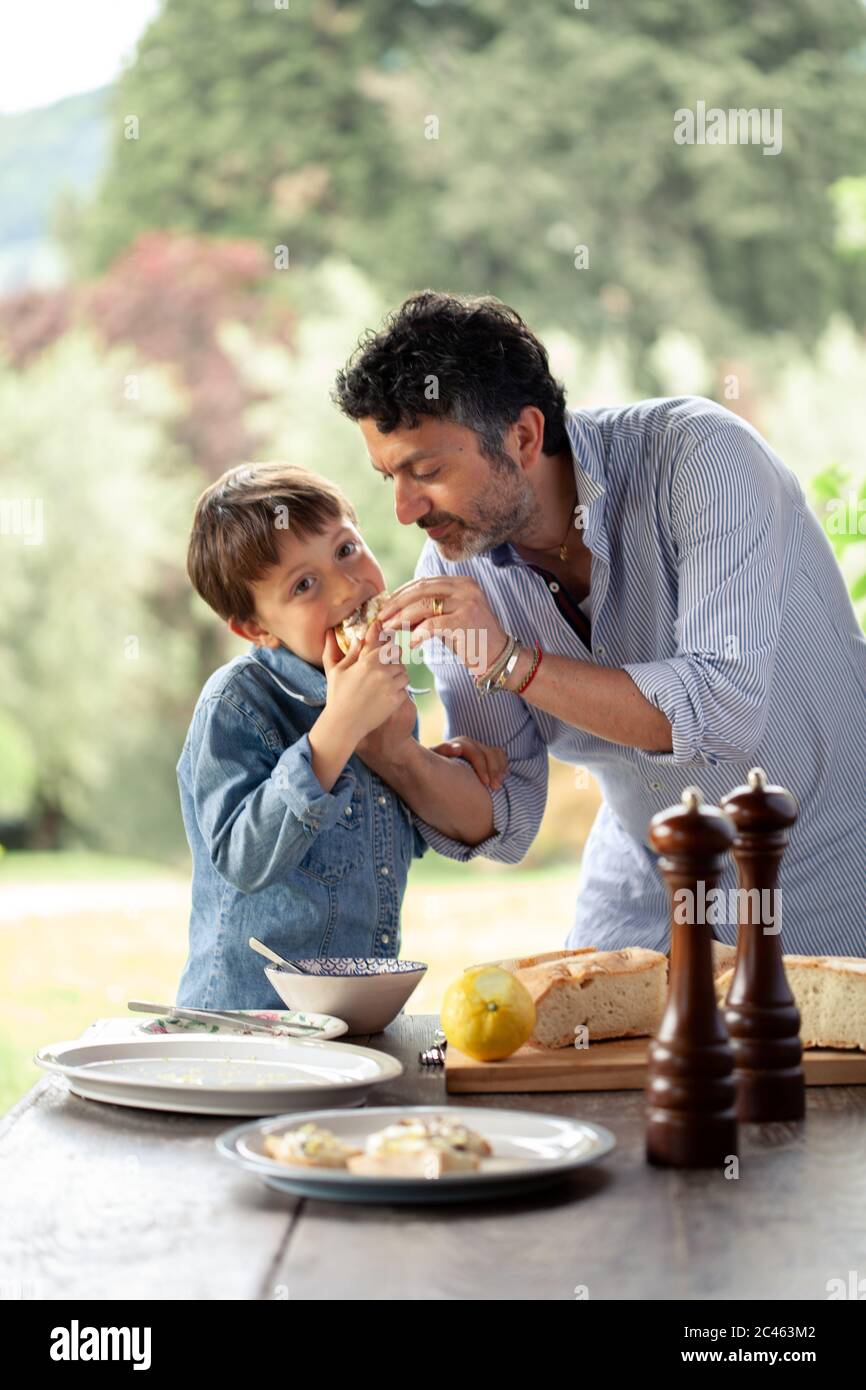Father and son eating bread Stock Photo - Alamy