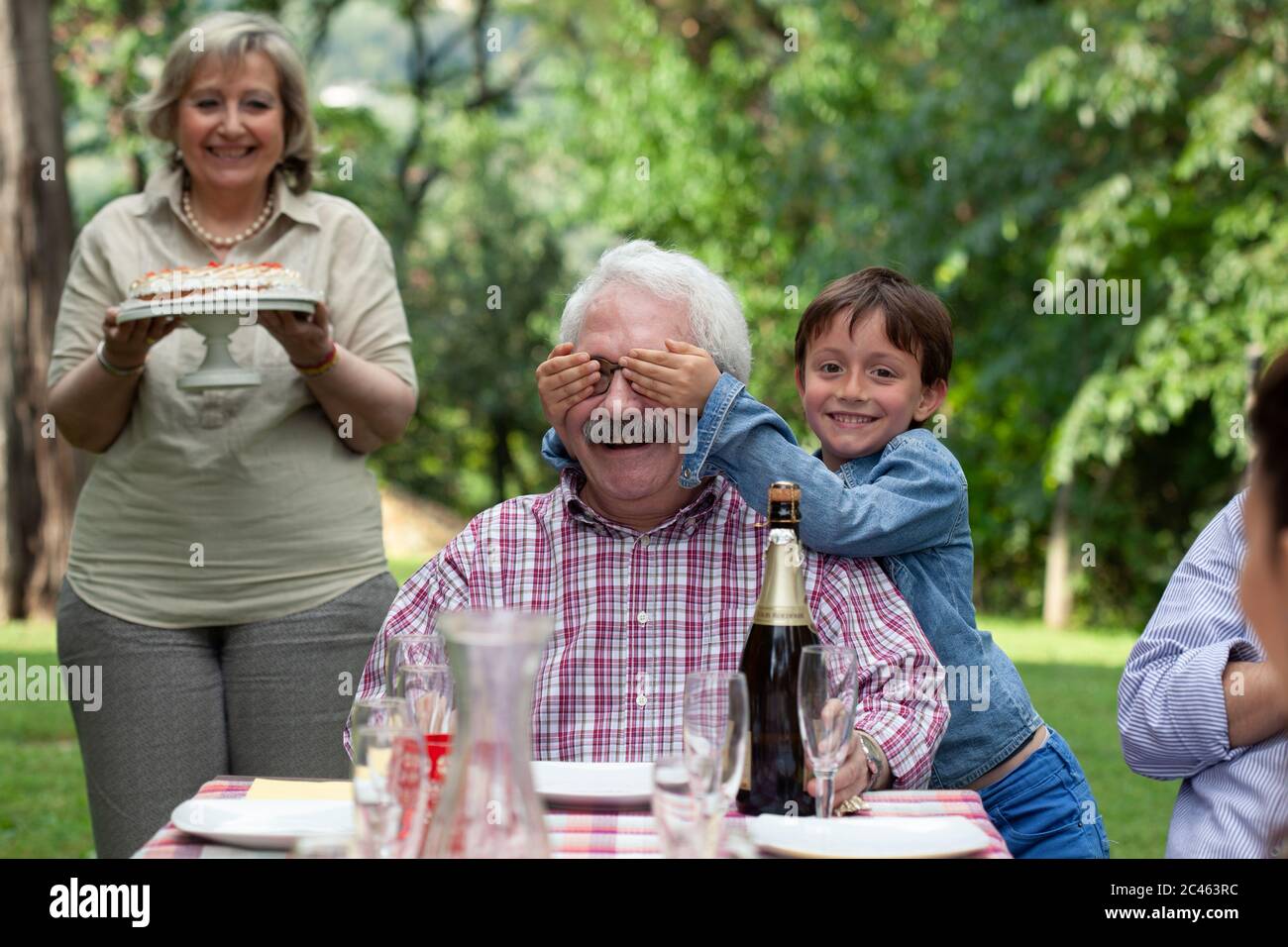 Senior man being surprised with birthday cake Stock Photo - Alamy