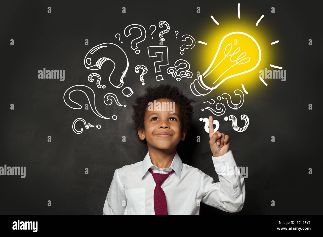 Smiling black child student with lightbulb on blackboard background ...