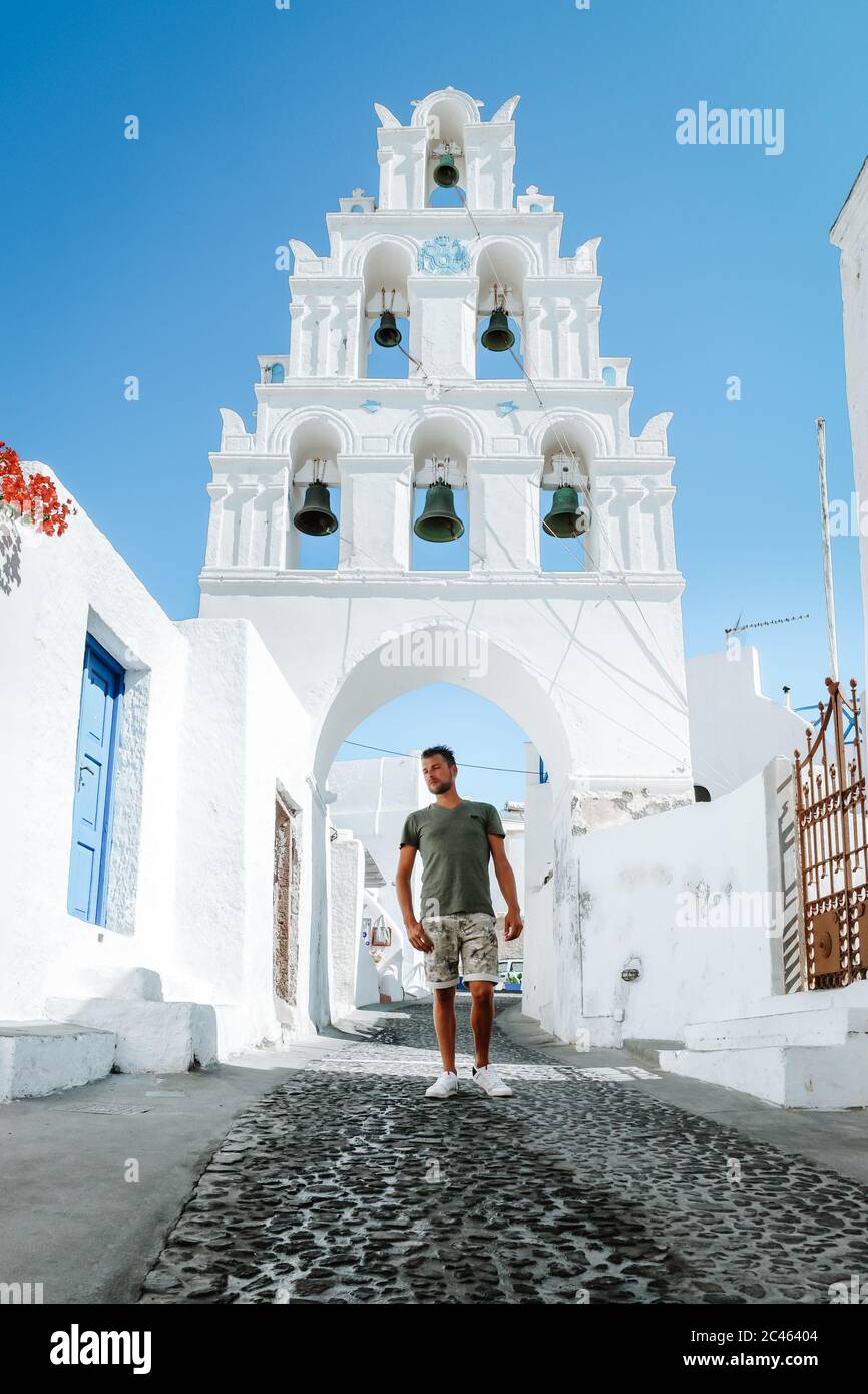 Santorini Greece, young men on vacation at the Island of Greece ...