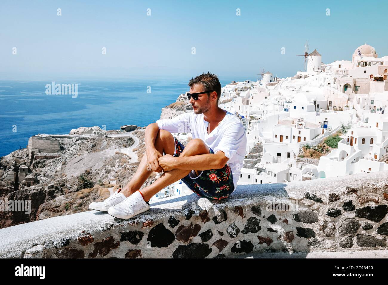 Santorini Greece, young men on vacation at the Island of Greece ...