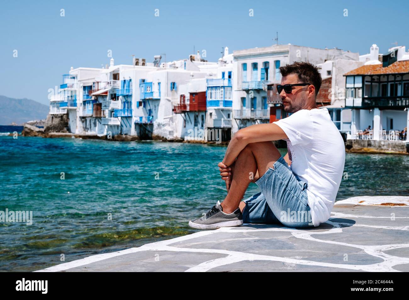 young guy on vacation at the Greek Island of Mykonos, men relaxing at ...