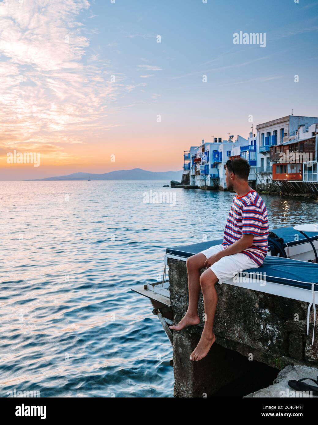 young guy on vacation at the Greek Island of Mykonos, men relaxing at ...