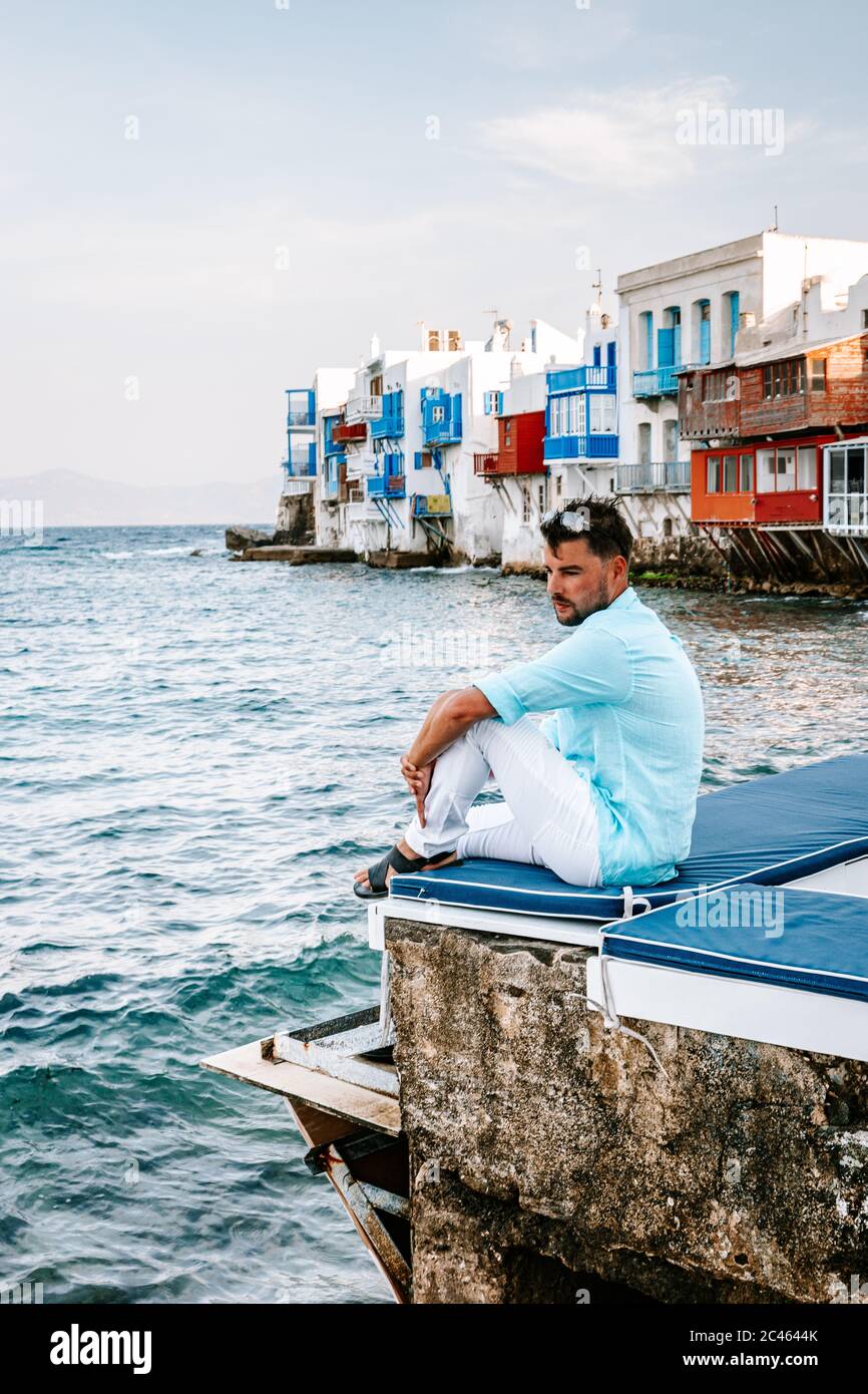 young guy on vacation at the Greek Island of Mykonos, men relaxing at ...