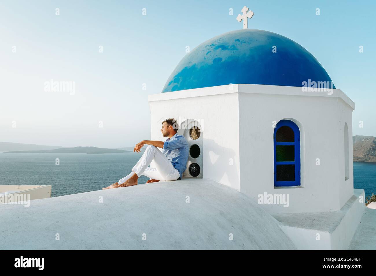 Santorini Greece, young men on vacation at the Island of Greece ...