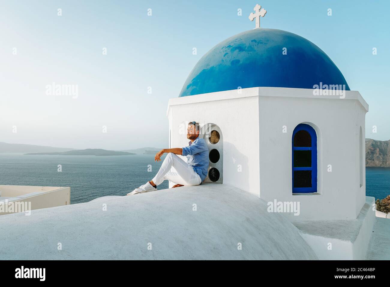 Santorini Greece, young men on vacation at the Island of Greece ...