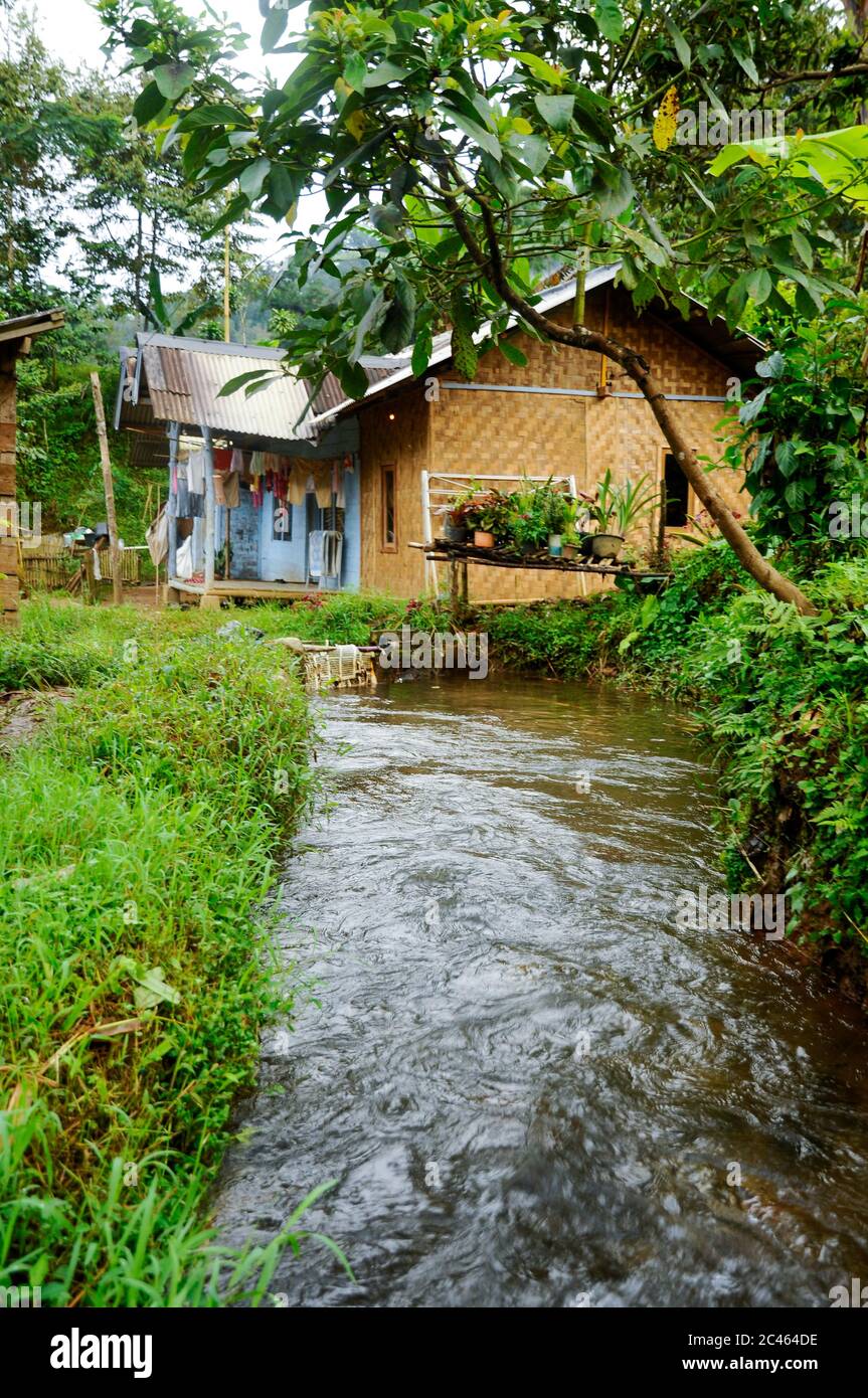 Rural mountain little village with river and typical Indonesian ...