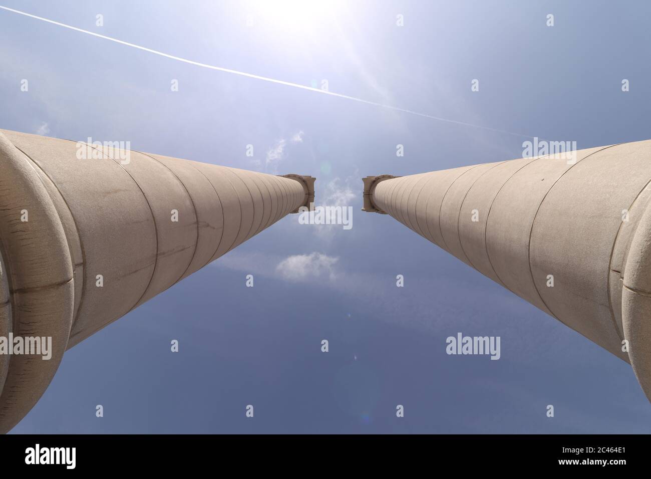 High columns made of white stone and the sun shining in the clear sky ...