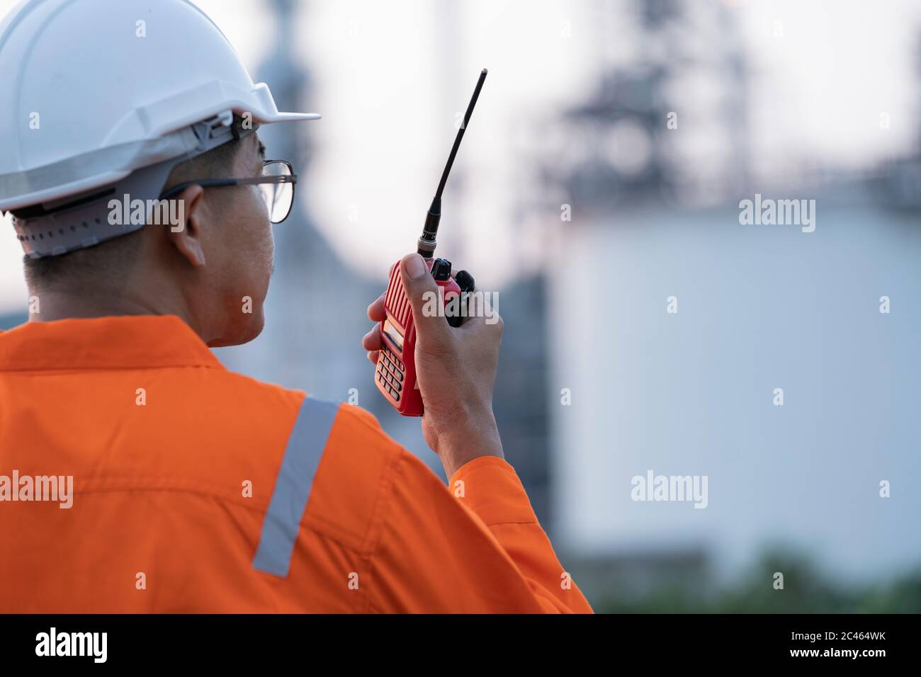 Male engineer workers on walkie-talkie outside the refinery Stock Photo ...