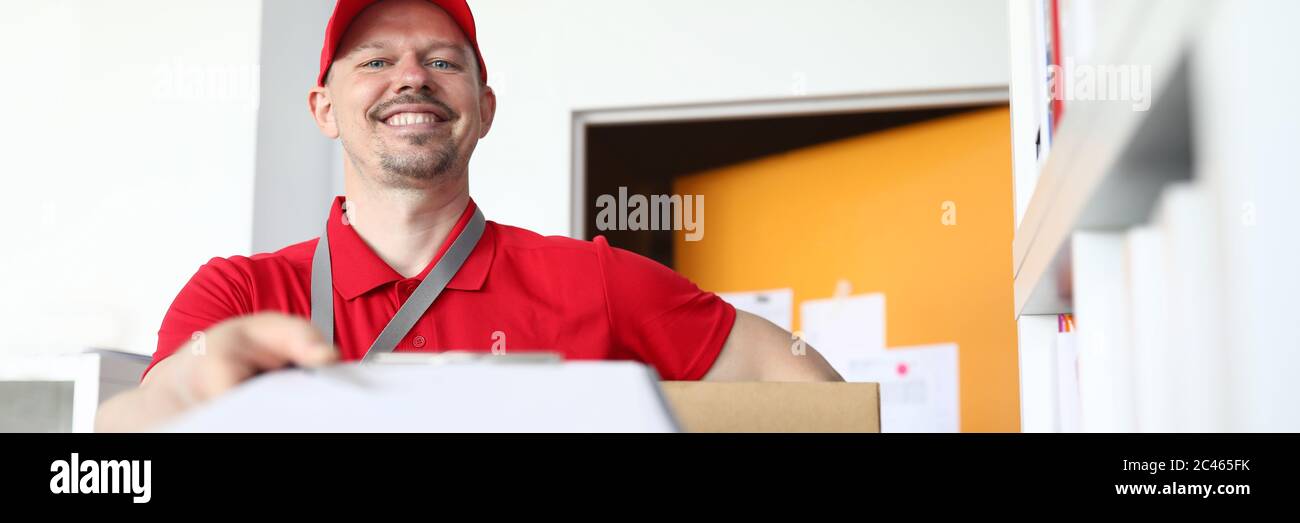 Courier smiling guy with package hi-res stock photography and images ...