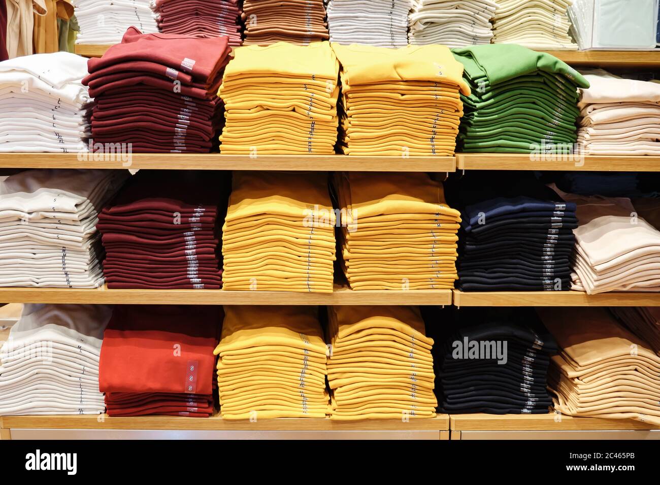 Shelf with folded shirts hi-res stock photography and images - Alamy