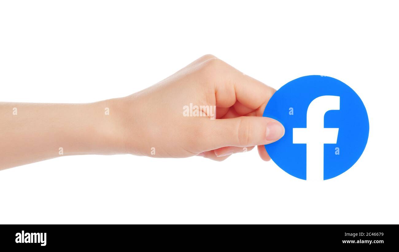 Kiev, Ukraine - May 15, 2019: Hand holds new Facebook logo printed on ...