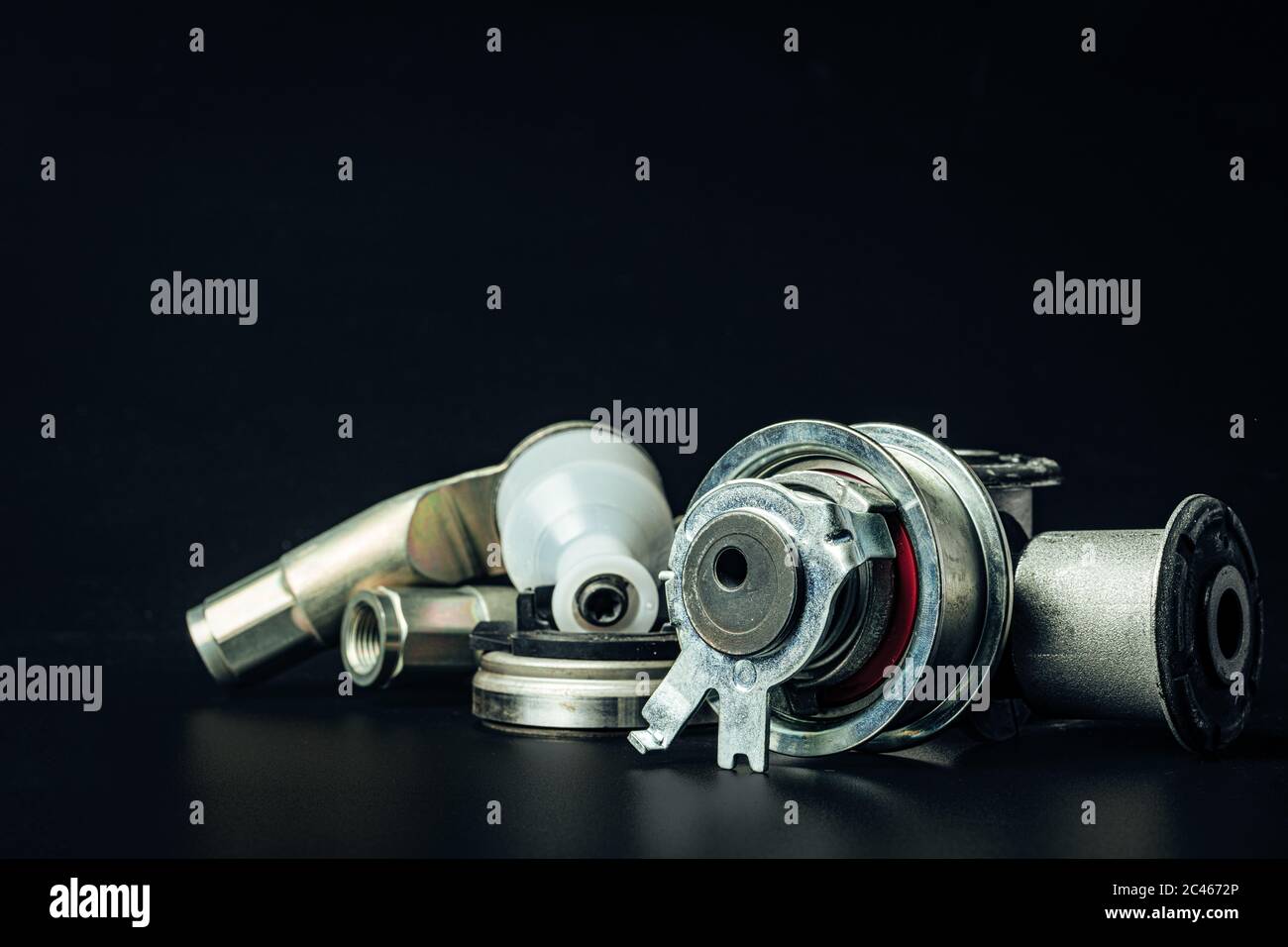 Metal car engine spare part on black background Stock Photo - Alamy