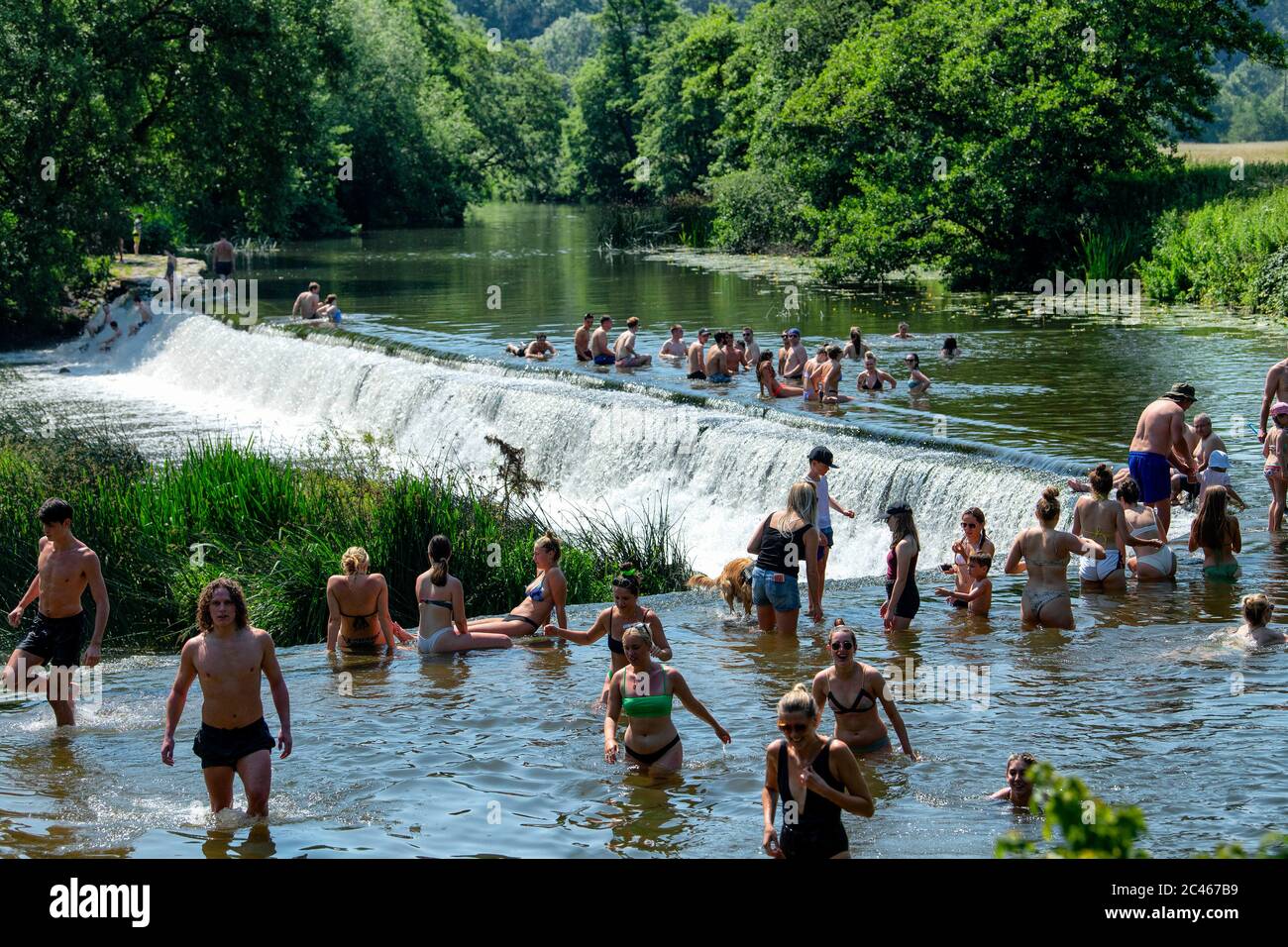 People enjoy the water at Warleigh Weir on the river Avon near Bath as ...
