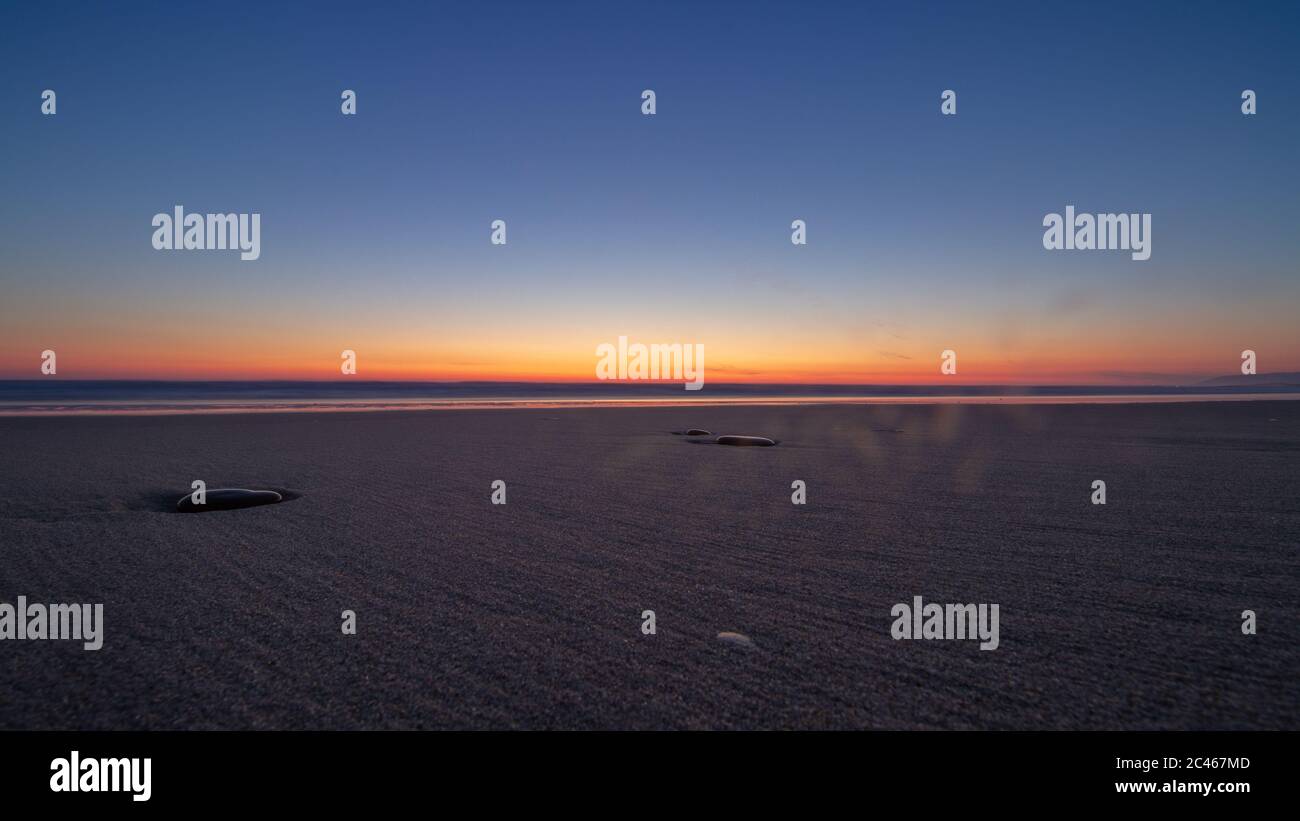 Beautiful shot of a sunset over the sea in Nazare, Portugal Stock Photo ...
