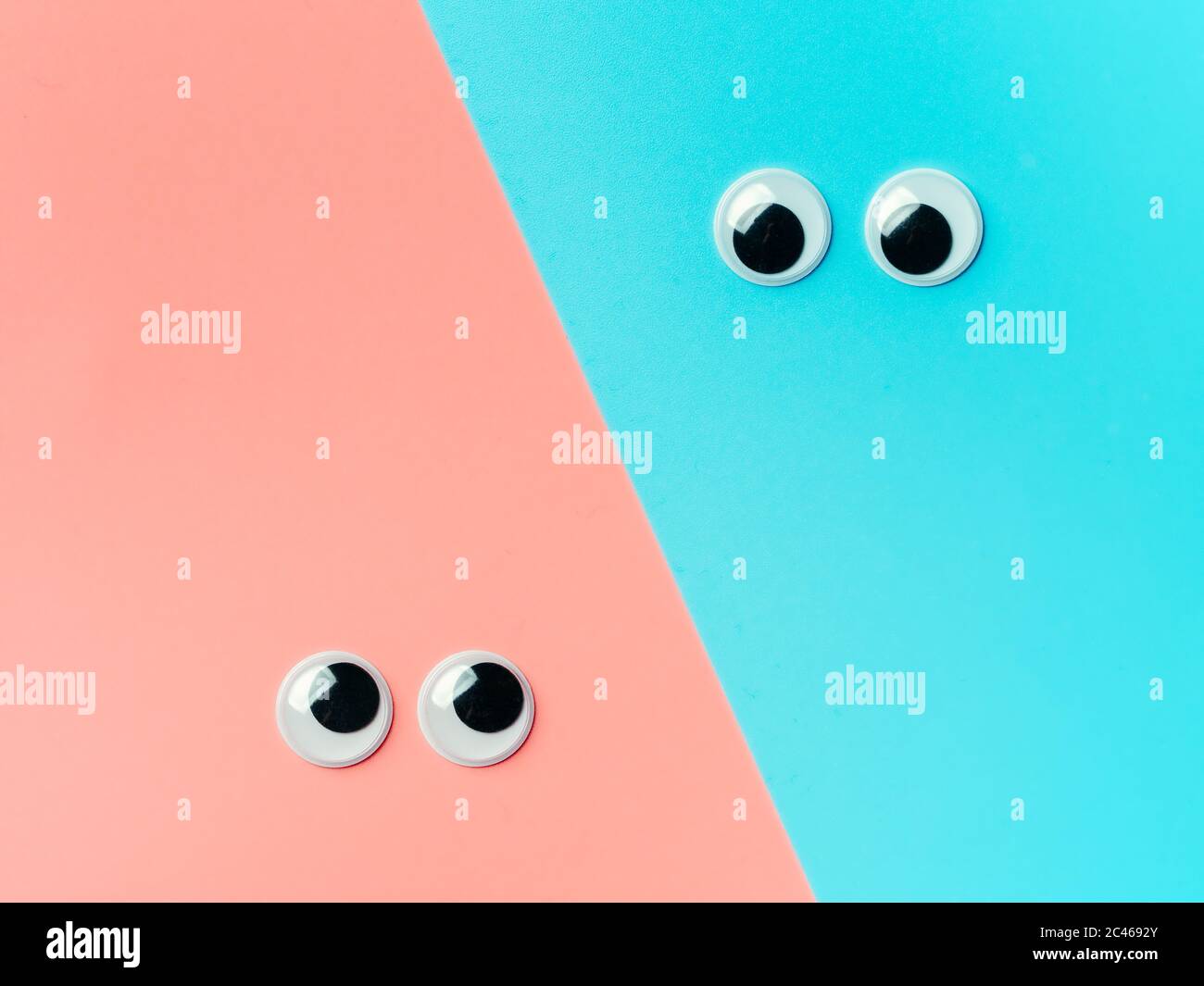 Googly eyes on blue an pink background. Top view or flat lay. Plastic ...