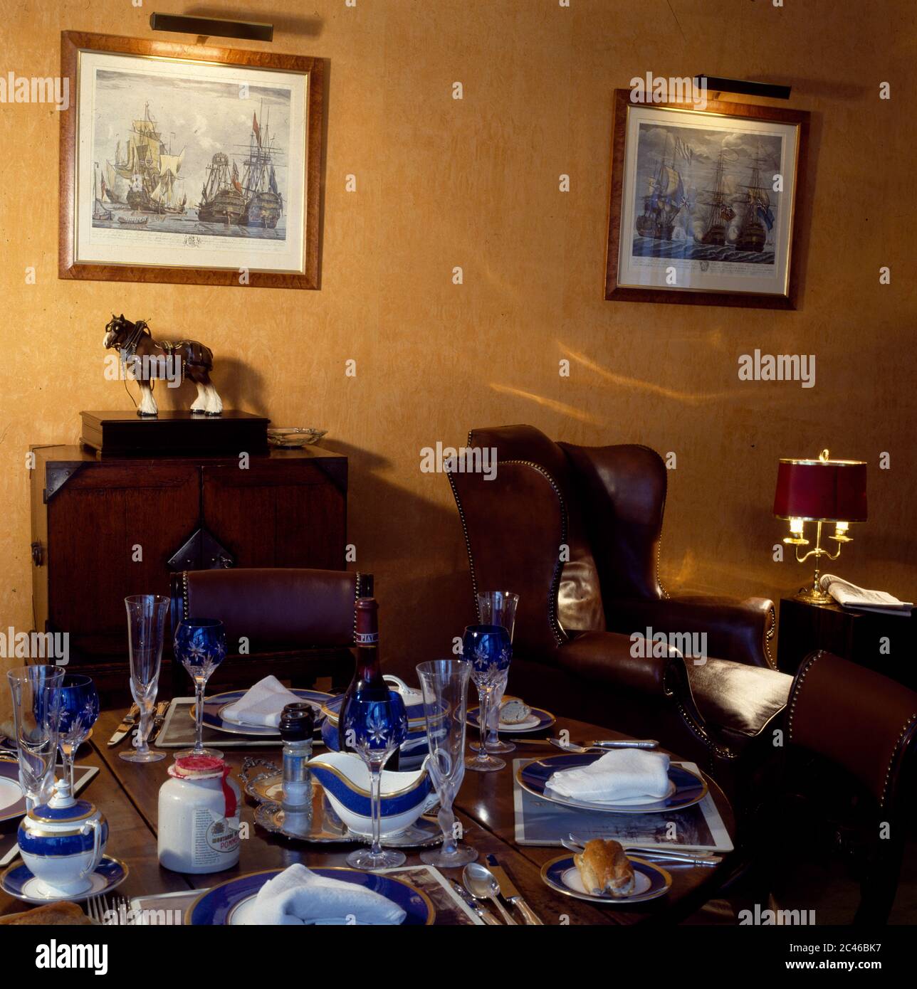 Close up of dining table set for meal with pictures in background Stock ...