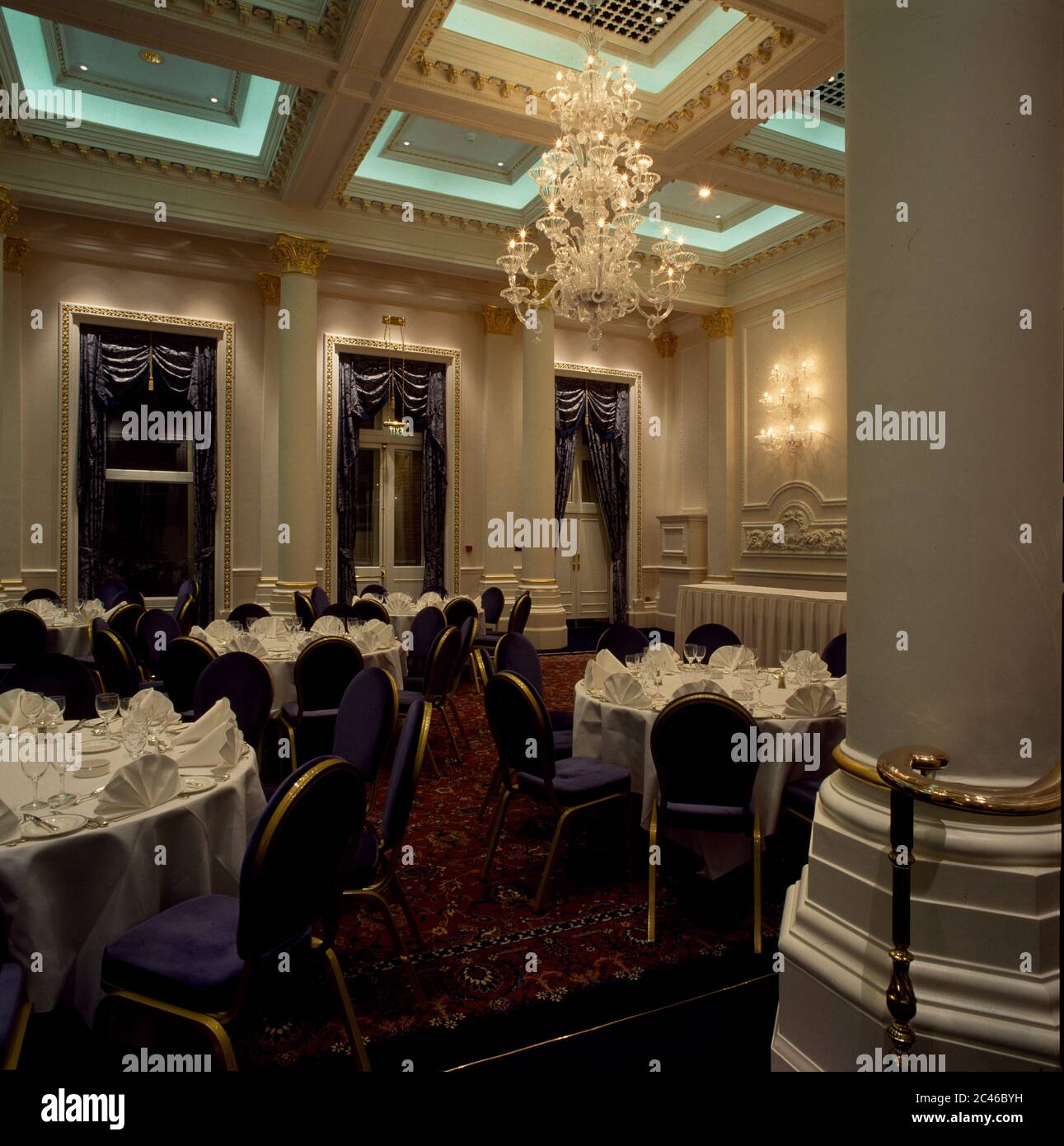 Tables in hotel diningroom set for event Stock Photo - Alamy