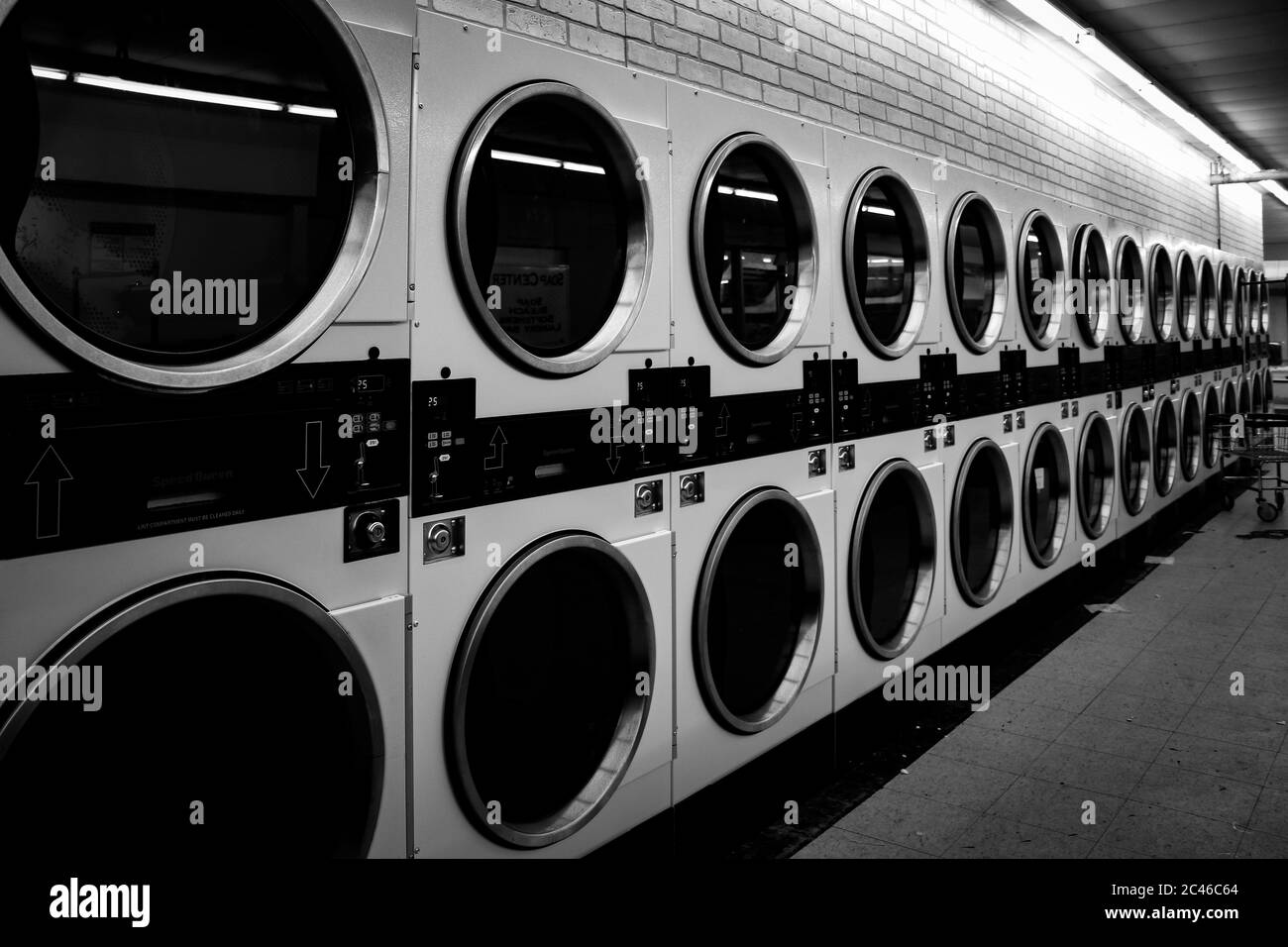 Grayscale shot of a laundry room with washing machines Stock Photo - Alamy