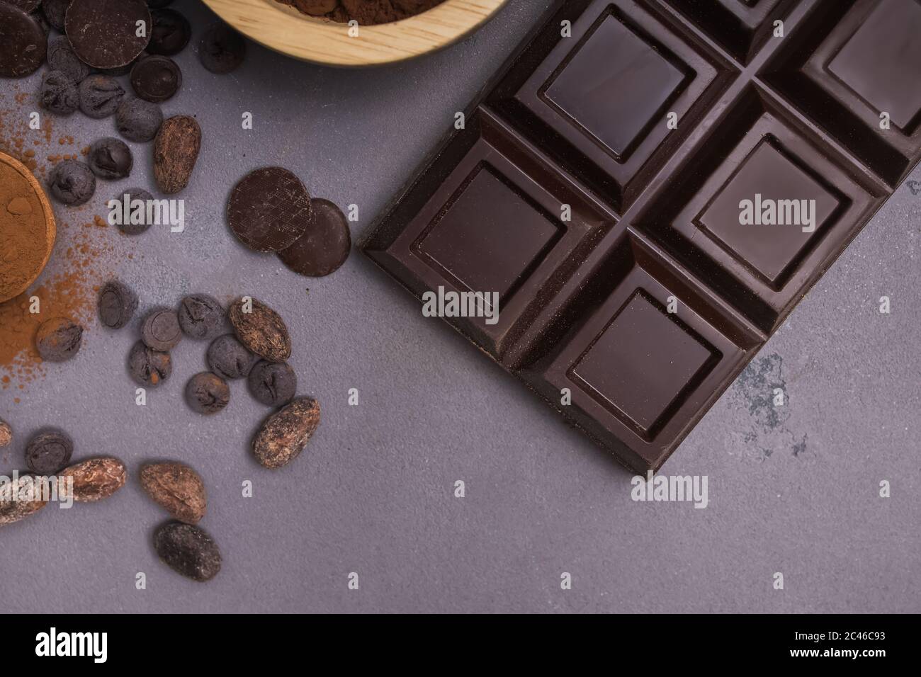 Chocolate bar and drops on the grey table Stock Photo - Alamy