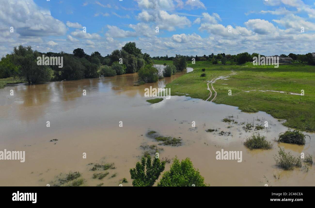 Water flowing in farm field waterway on a field flooded damage after ...