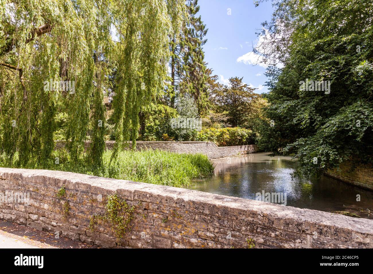 The River Coln flowing past the gardens of Ablington Manor in the ...