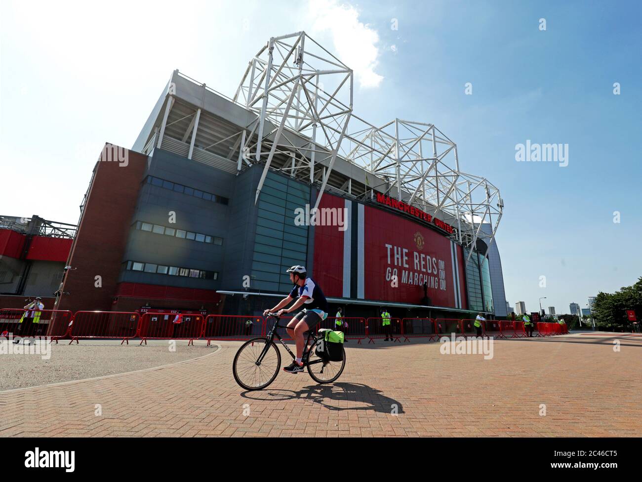 A fan cycles past old trafford hi-res stock photography and images - Alamy