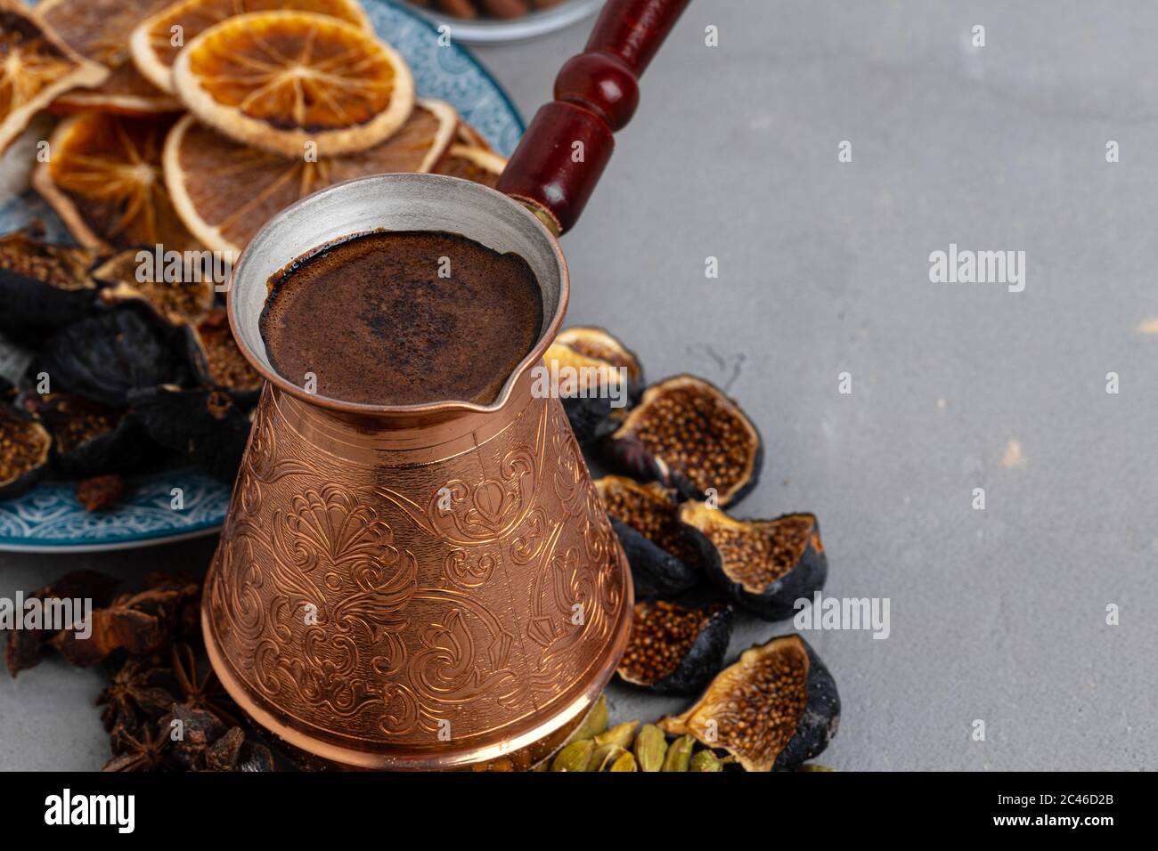 Copper coffee turk with dried seeds and fruits on grey surface Stock ...