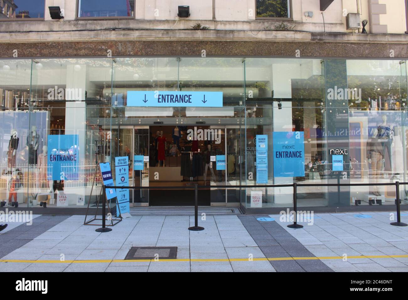 A photograph of the Cardiff Next store, with social distancing markers ...