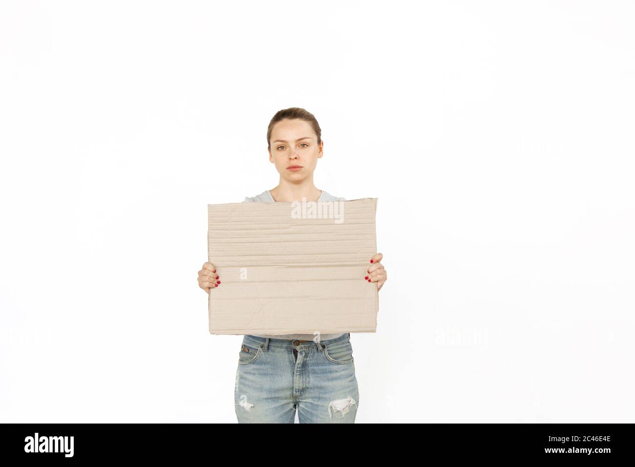 Young woman protesting with blank board, sign isolated on white studio ...