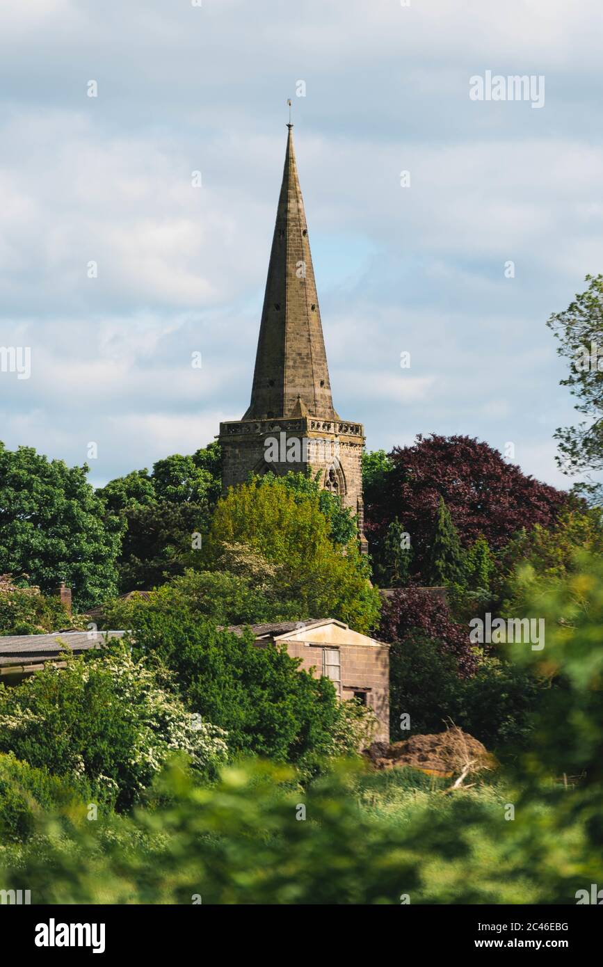 Vertical shot of a beautiful spire surrounded by trees Stock Photo - Alamy