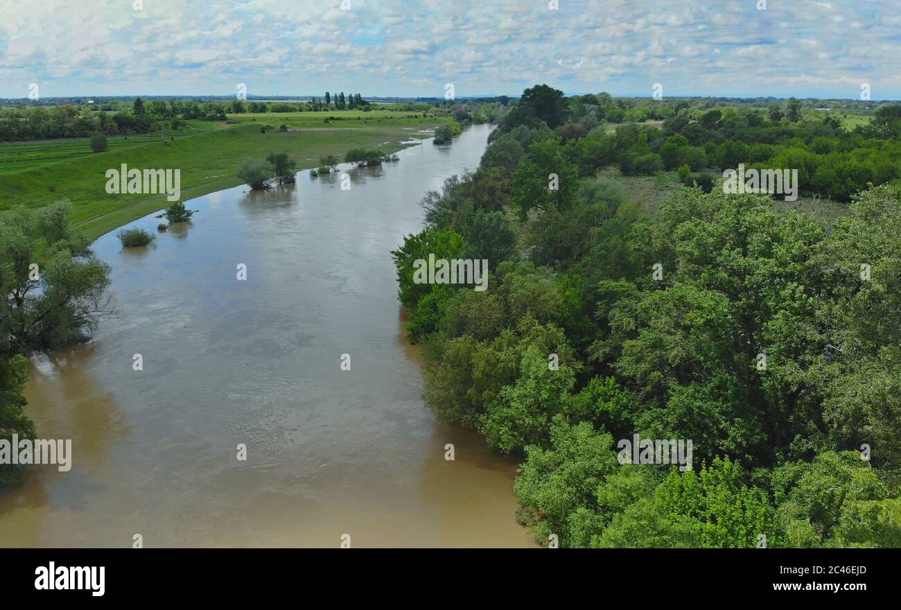 Water flowing in farm field waterway on a field flooded damage after ...