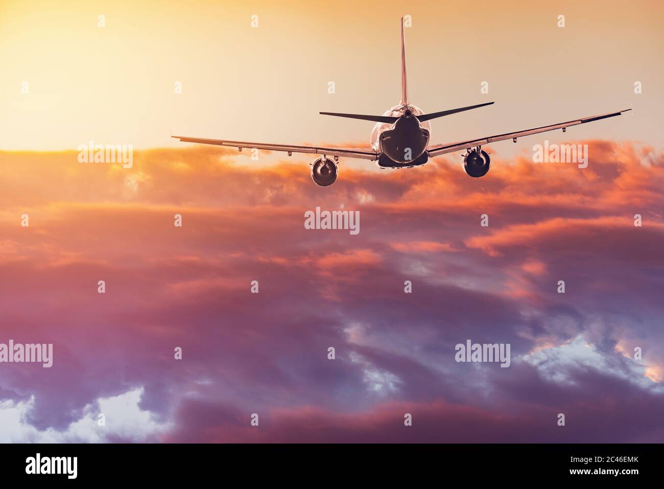 Passenger plane flies above the sunset sky Stock Photo - Alamy