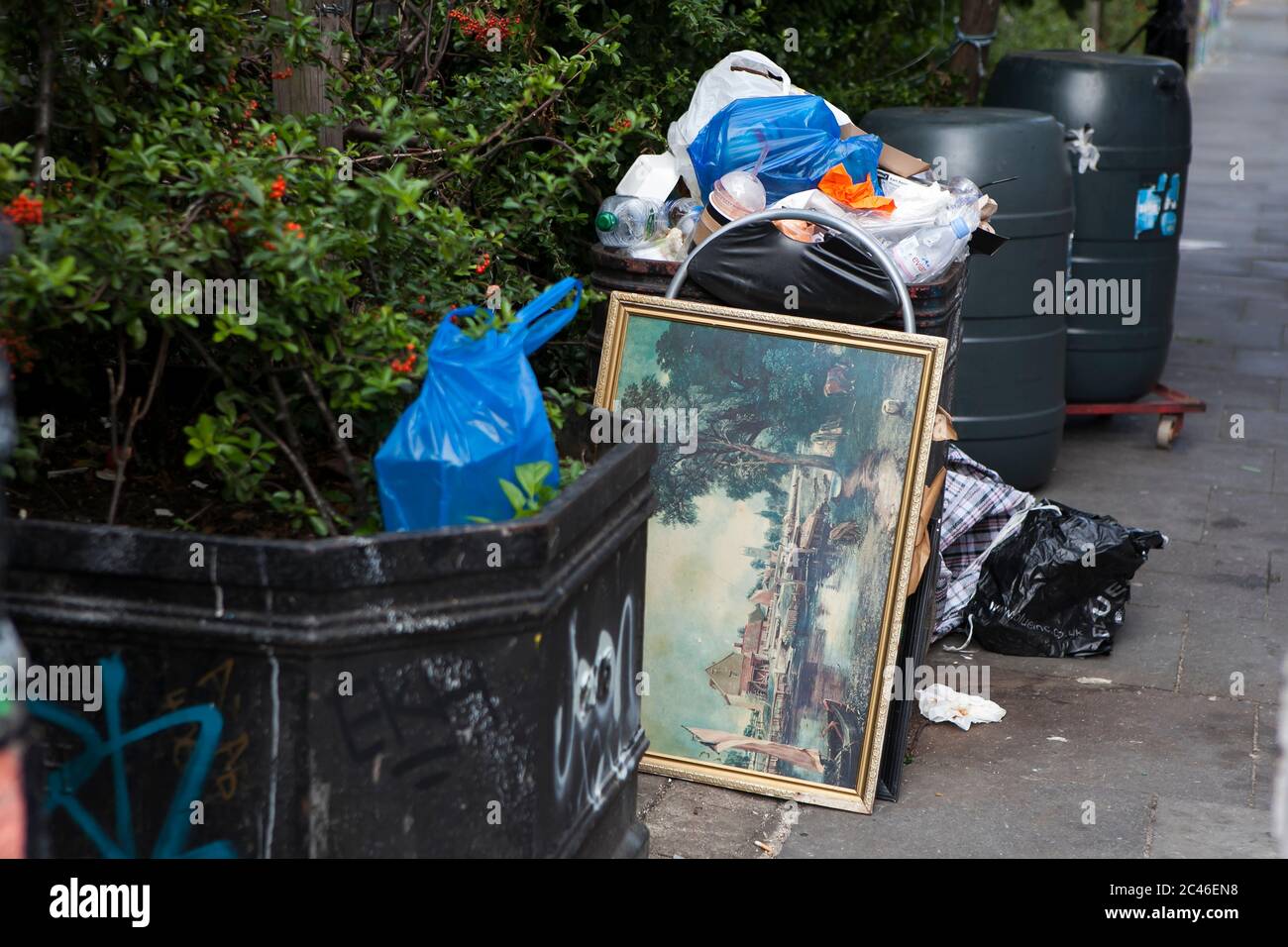 London, UK - 17 July 2019, A discarded oil painting in a garbage dump ...