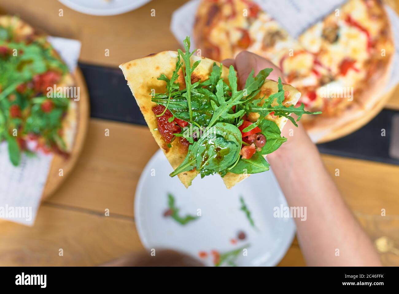 meal time at pizzeria, man taking a slice of the pizza shot with very ...