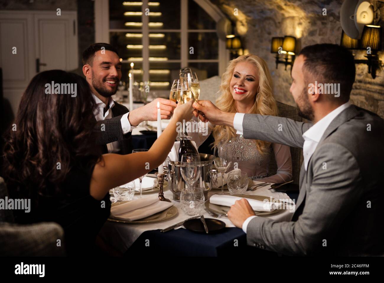 Party, holiday with friends concept. Four people with champagne glasses ...