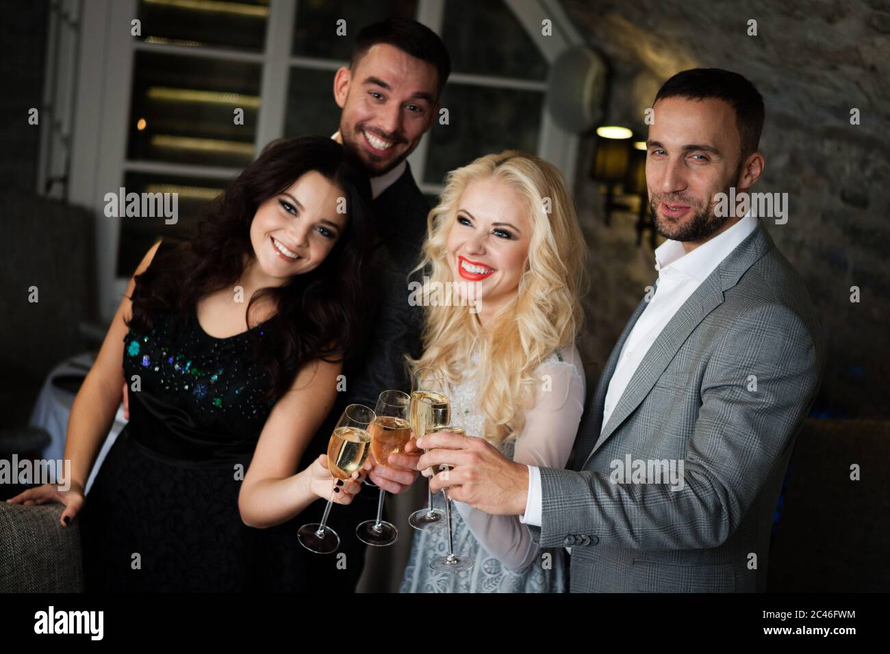Party, holiday with friends concept. Four people with champagne glasses ...
