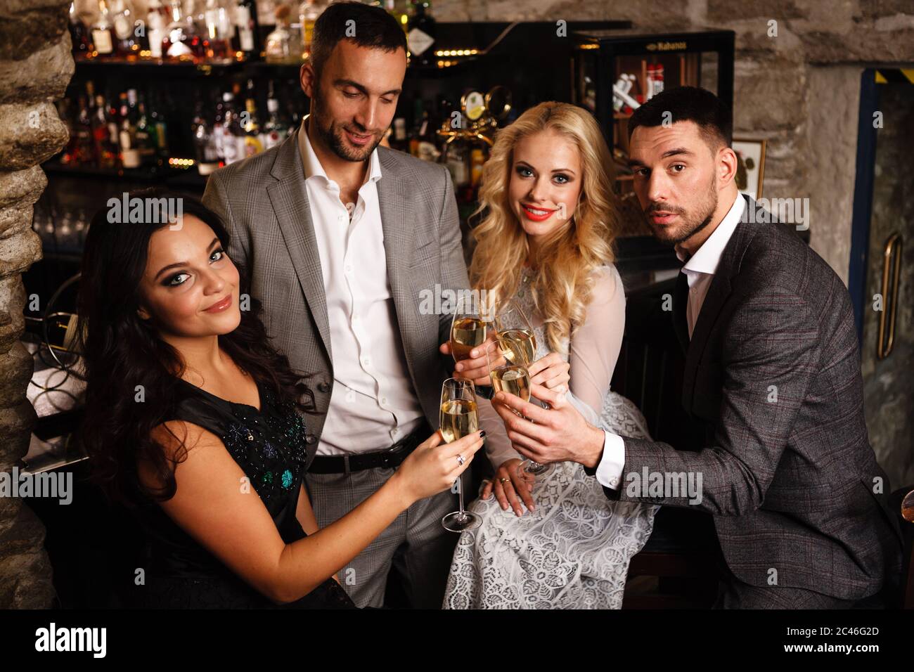 Party, holiday with friends concept. Four people with champagne glasses ...