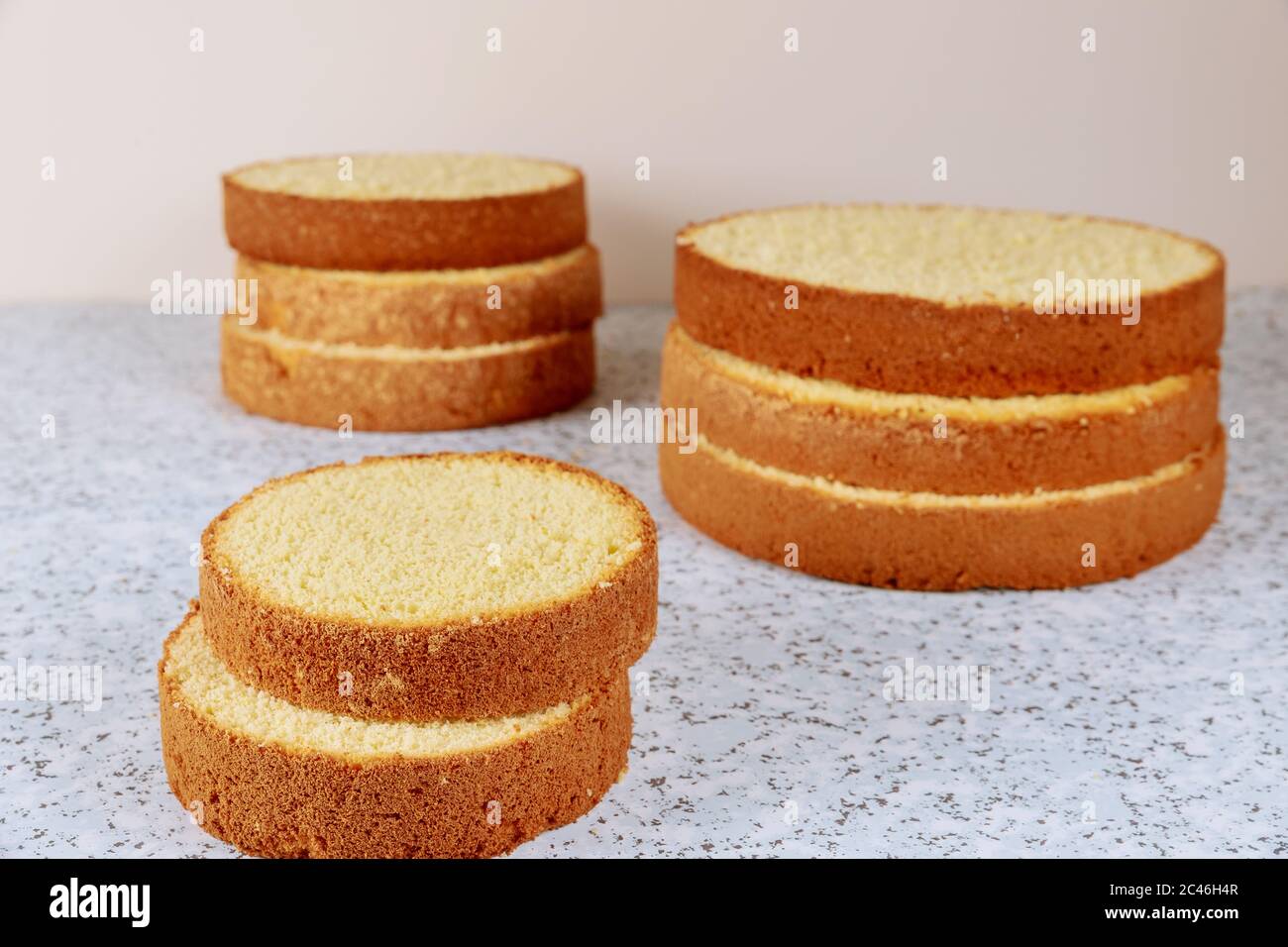 Sponge cake layers. Making layered wedding cake Stock Photo - Alamy
