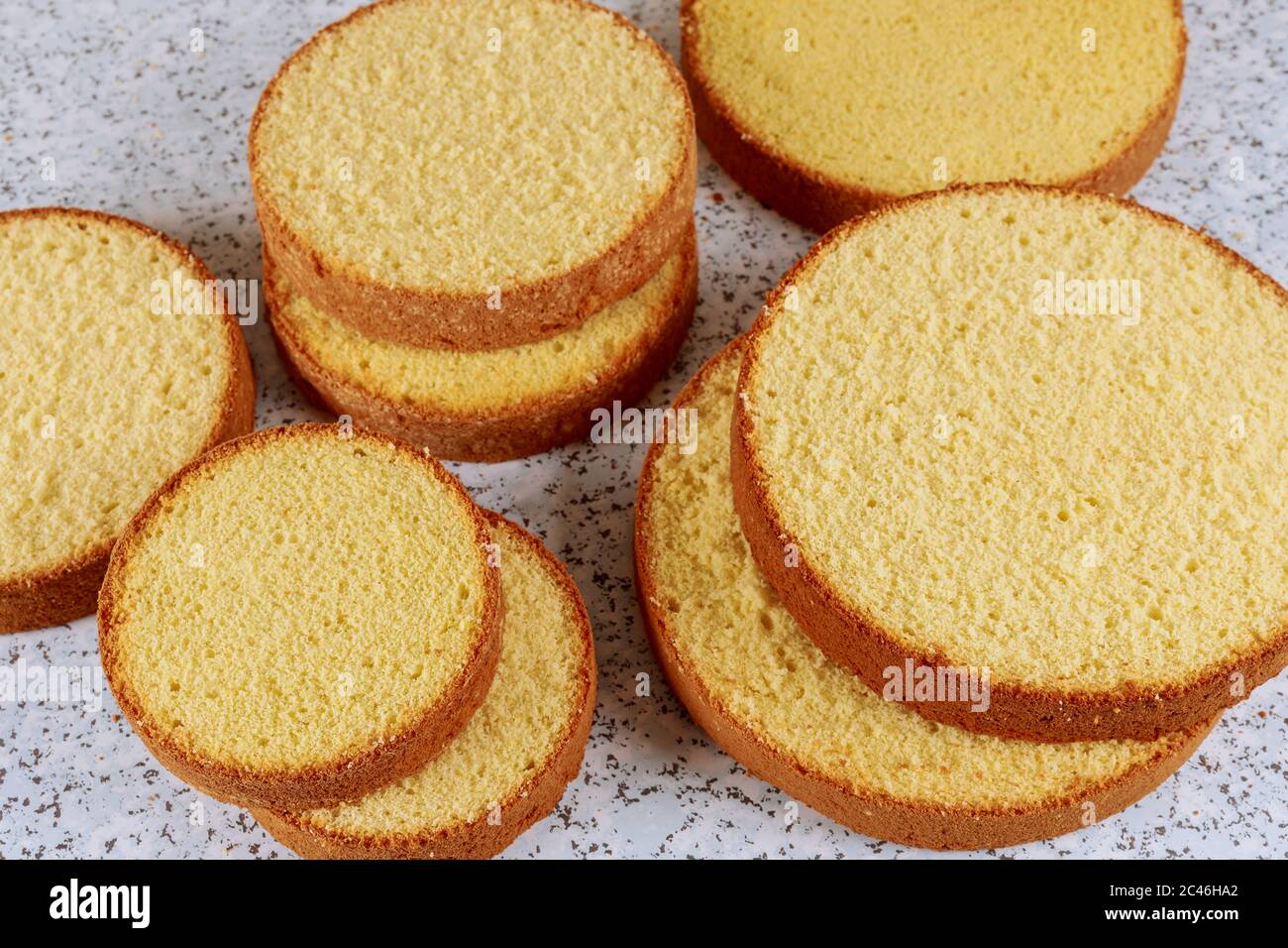 Oven baked and sliced sponge cake for making party cake Stock Photo - Alamy