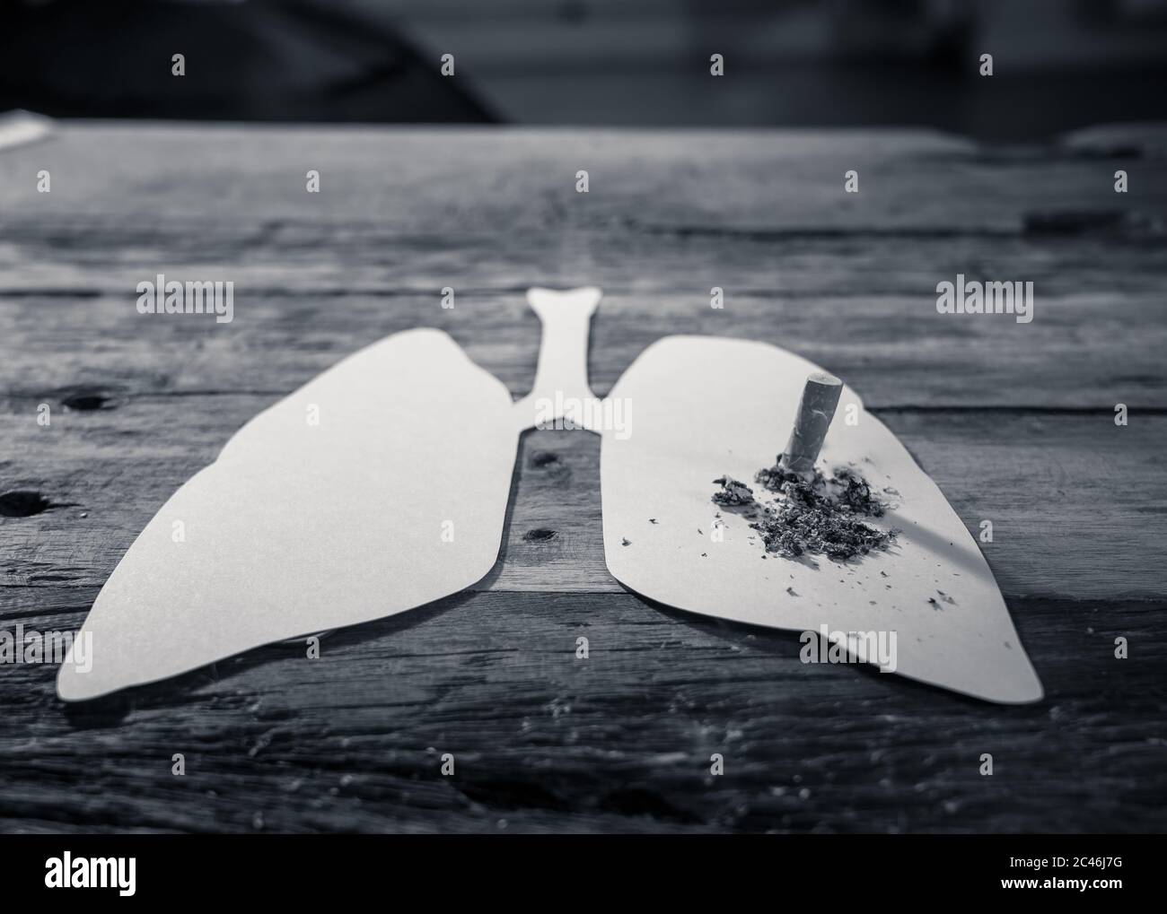 Conceptual image of cigarette burning on paper lungs isolated on rustic ...