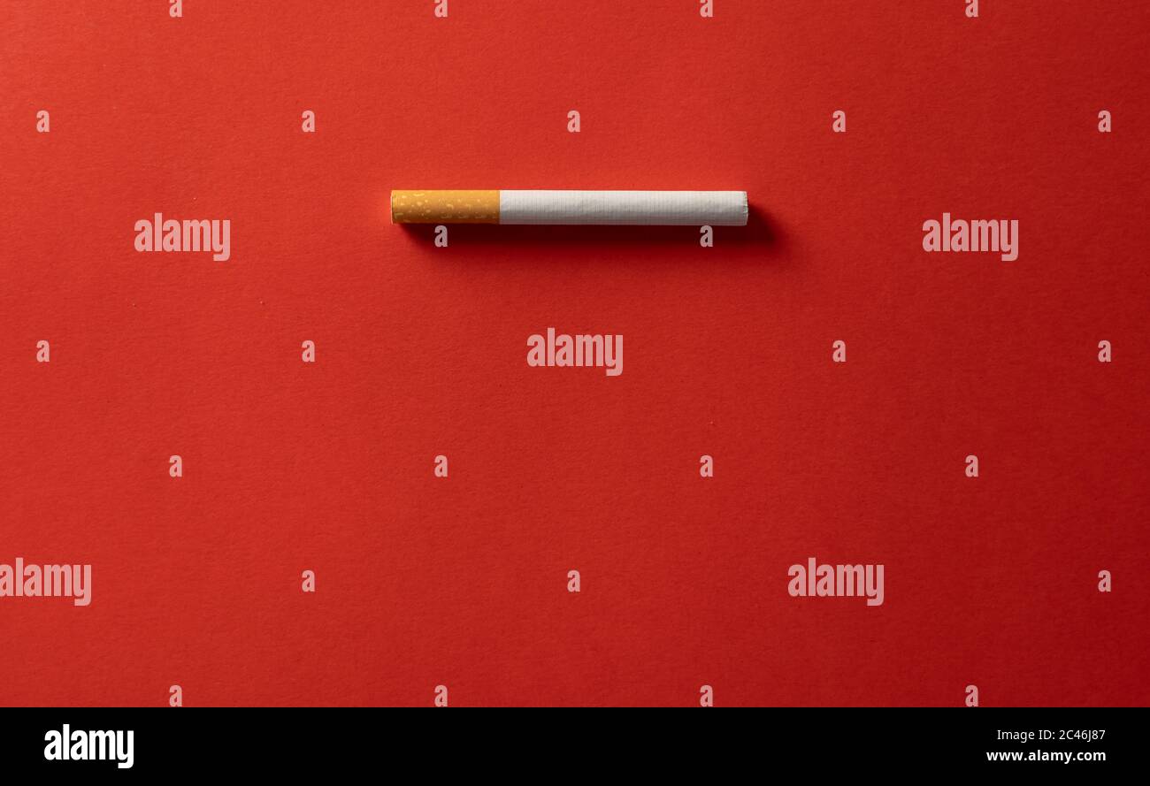 Cigarette isolated on red background. Conceptual image with copy space ...