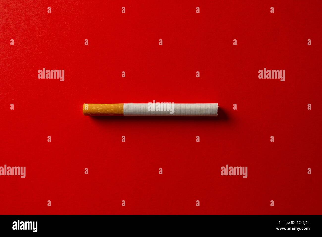 Cigarette isolated on red background. Conceptual image with copy space ...