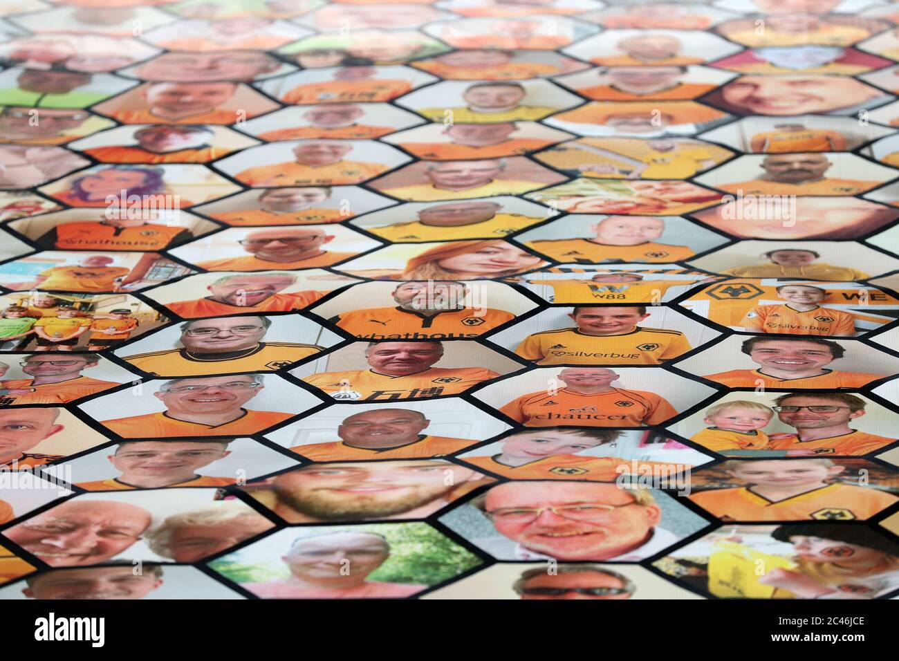 A large banner with Wolves fans printed on covers the stadium seating ...